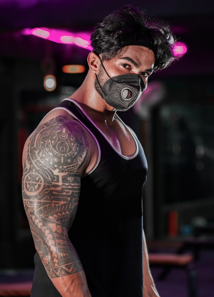 Bodybuilder wearing mask at gym - PixaHive