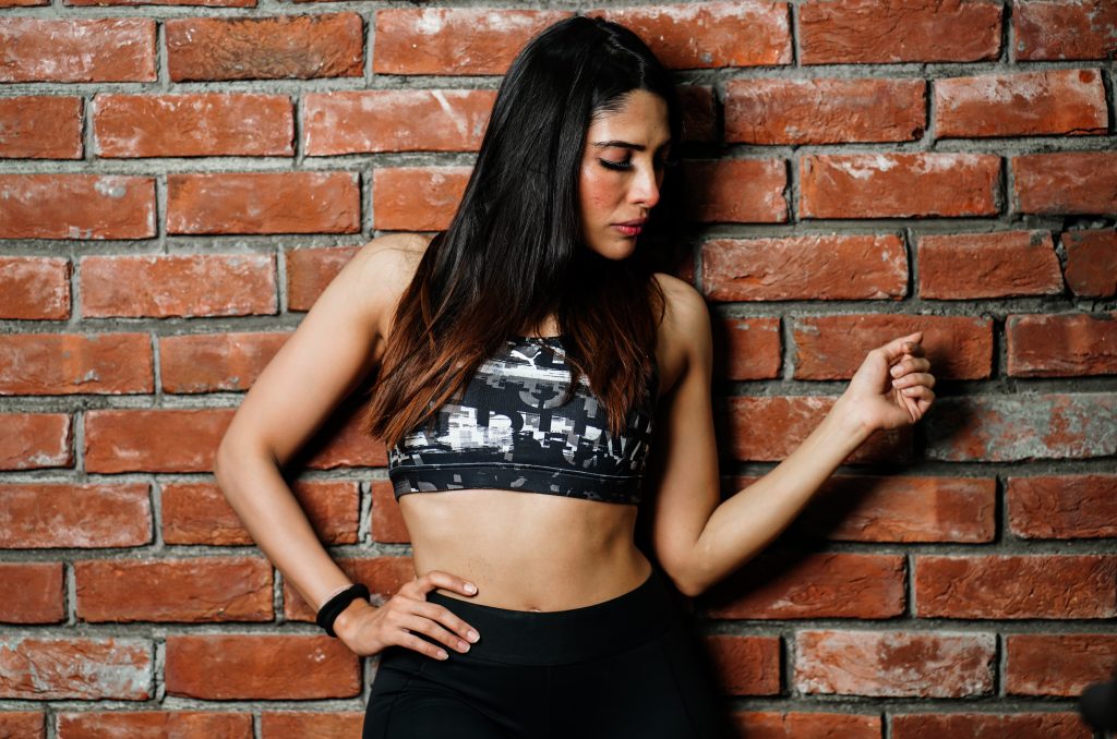 Female stand with brick wall - PixaHive