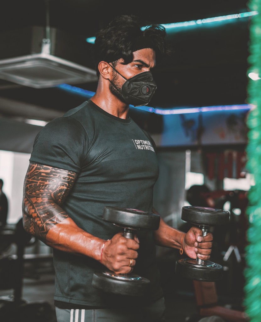 Man with dumbbells pumping muscle - PixaHive