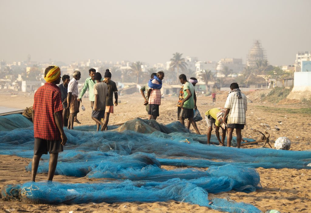 Fishermen preparing fishing net on the beach - PixaHive