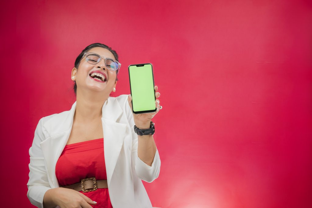 Happy professional woman presenting mobile phone - PixaHive