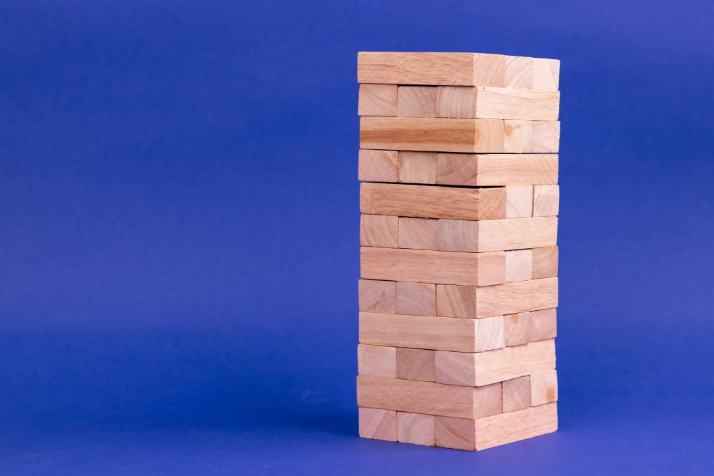 Jenga tower on blue background - PixaHive