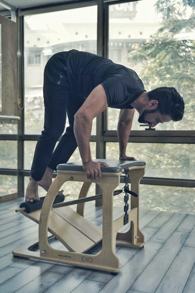 Man Exercising with Pilates Chair - PixaHive