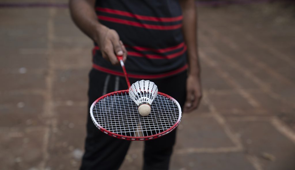 Man holding badminton racket and shuttlecock - PixaHive