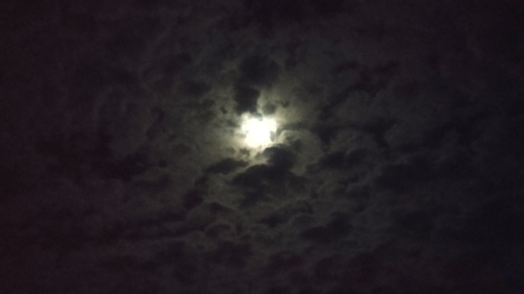 Moon between dark clouds - PixaHive