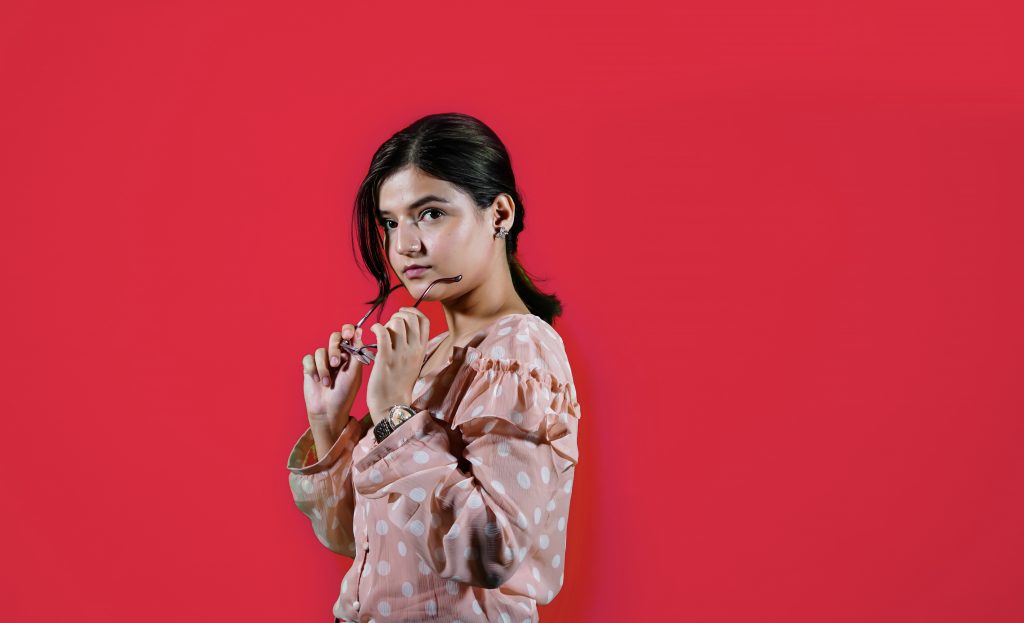 A Beautiful Model with Specs in Red Background - PixaHive