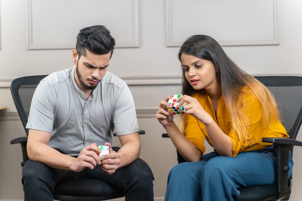 A girl and boy solving rubik cube - PixaHive