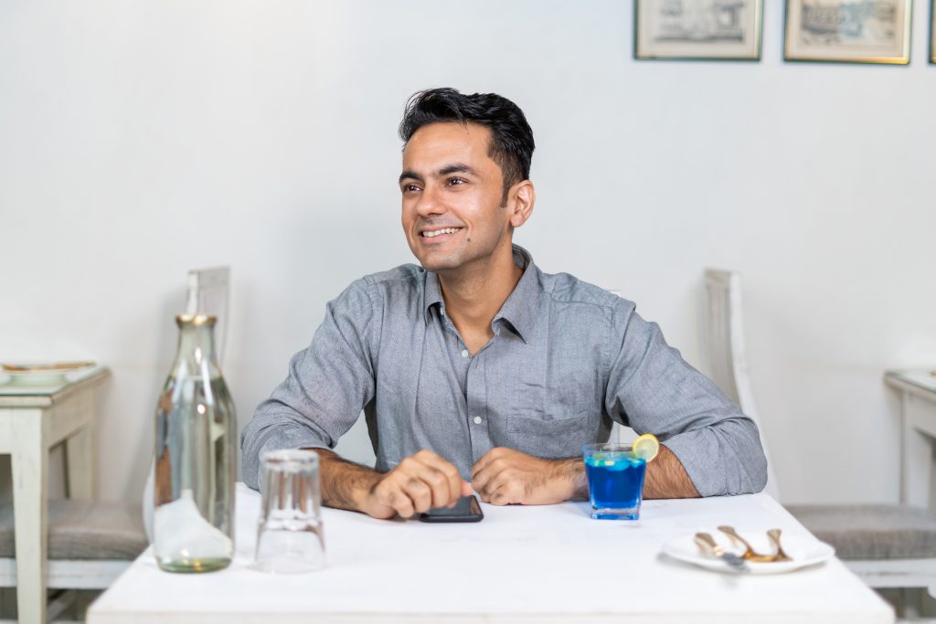 A handsome man looking at someone in cafe - PixaHive
