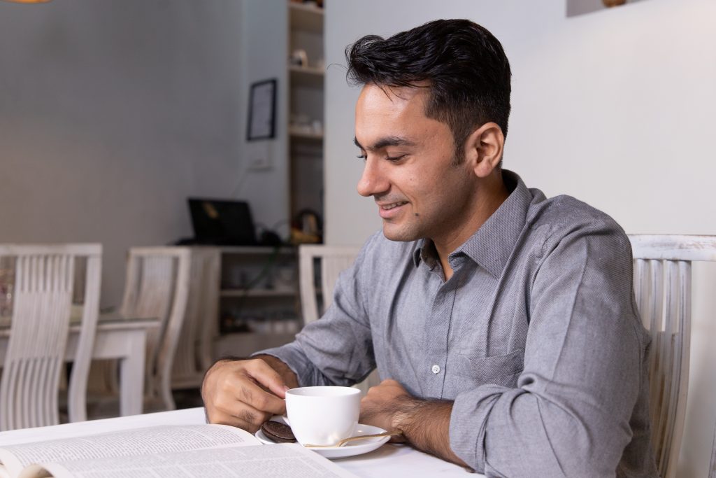 A man reading book in cafe - PixaHive