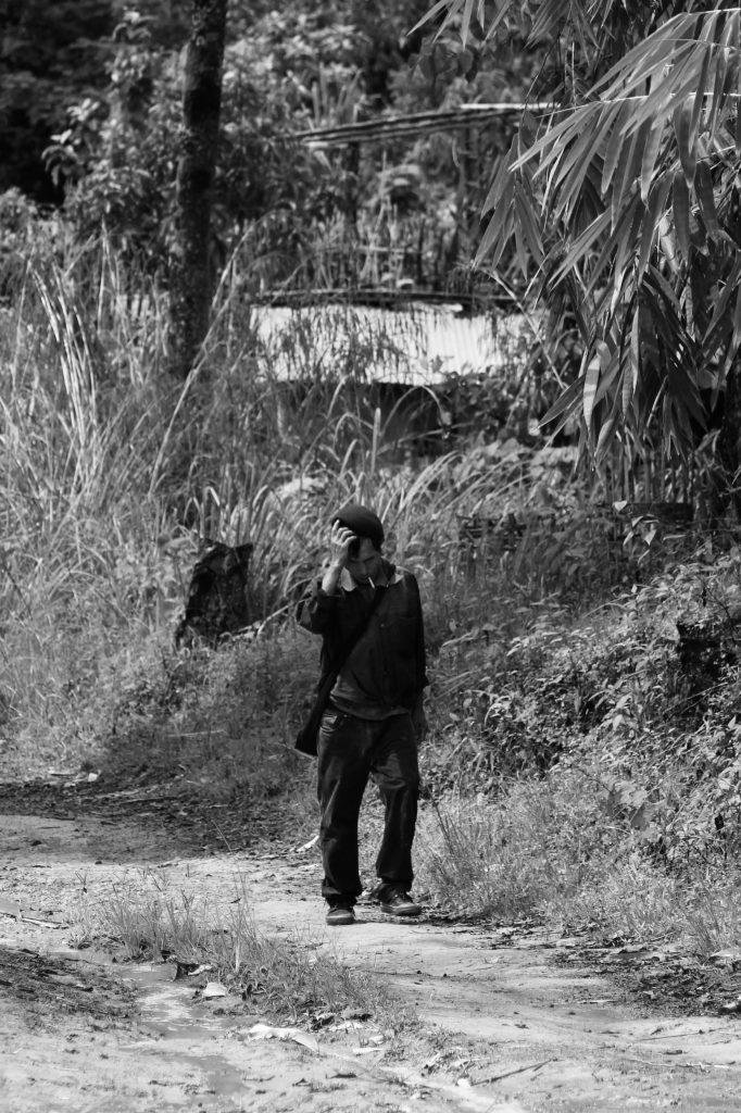 A man walking on a dirt road - PixaHive