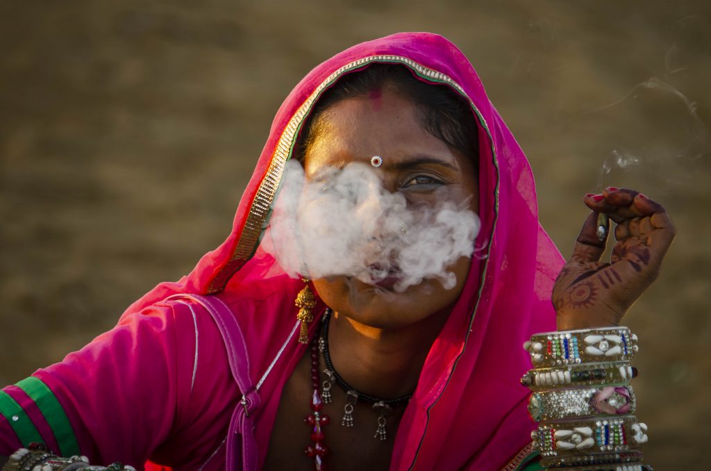 A tribal woman smoking - PixaHive
