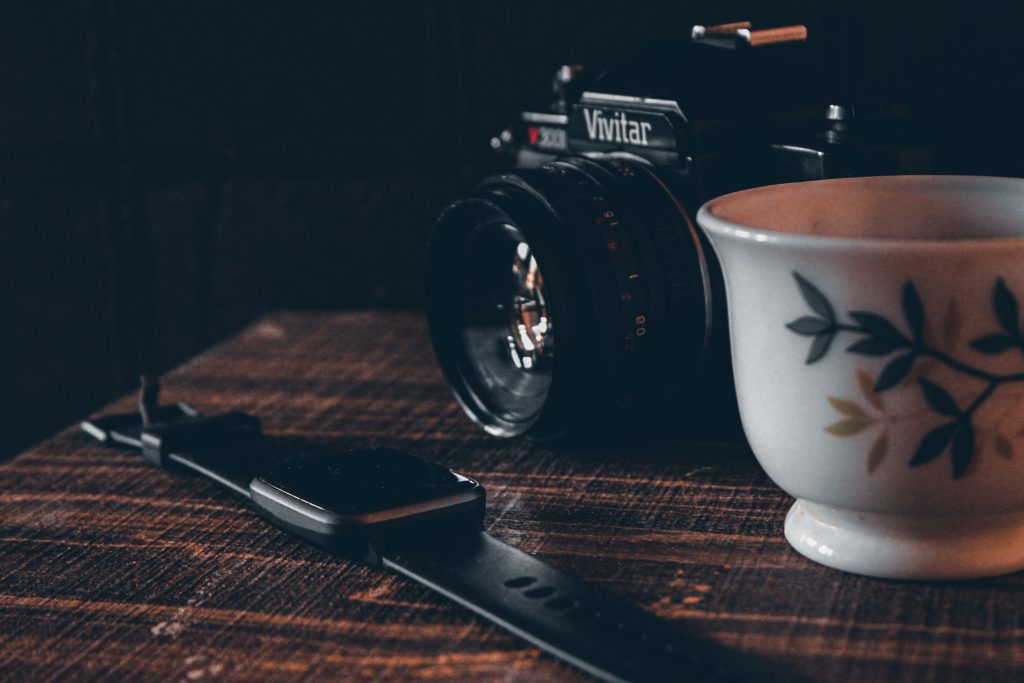 A watch and camera on a table - PixaHive