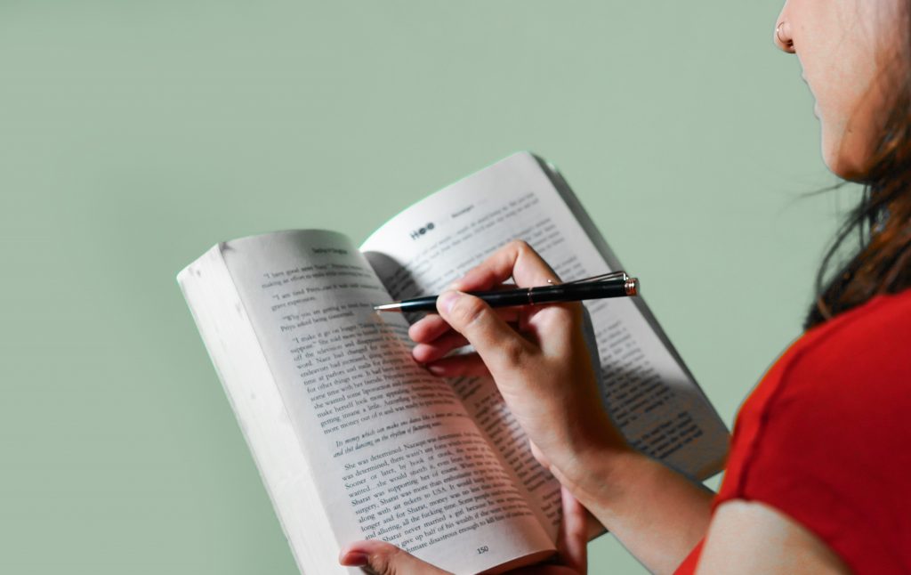 Girl highlighting lines in a book - PixaHive