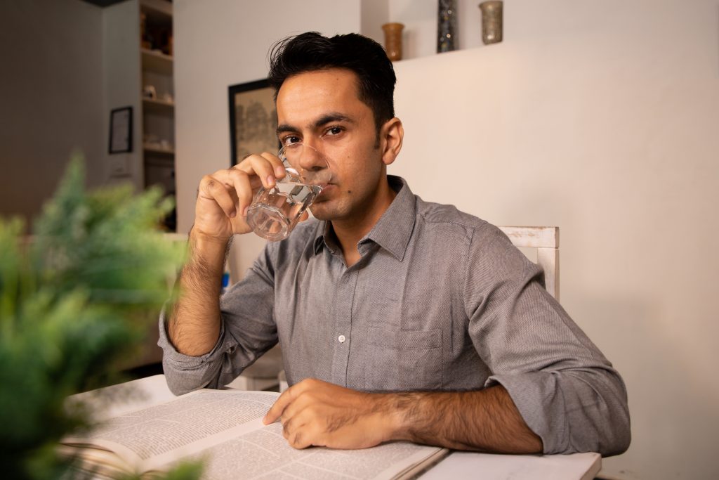 Handsome man drinking water in cafe - PixaHive
