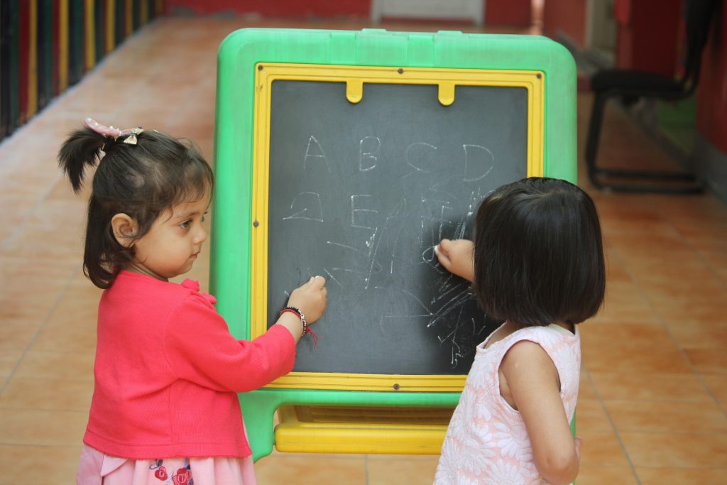 Kids writing on a small blackboard - PixaHive