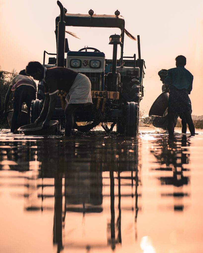 People washing a tractor in a pond - PixaHive