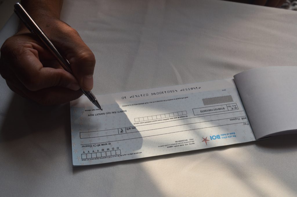 Signing a Cheque book - PixaHive