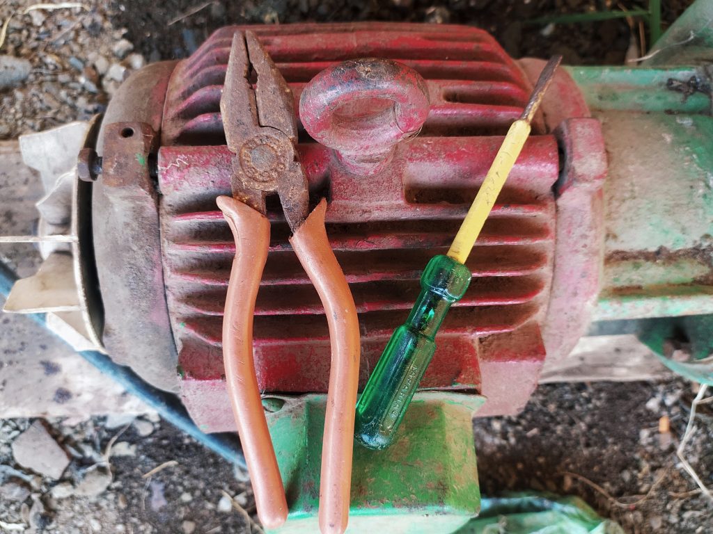 A plier and screwdriver on a motor - PixaHive