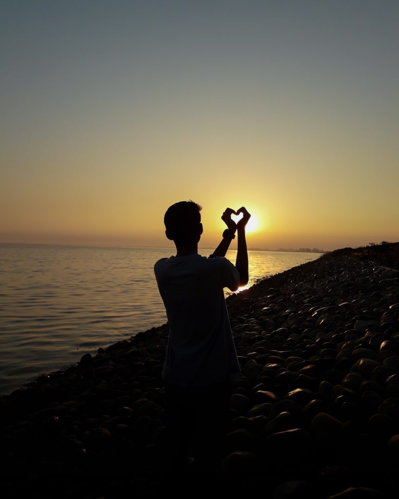 Boy make heart shape through sun - PixaHive