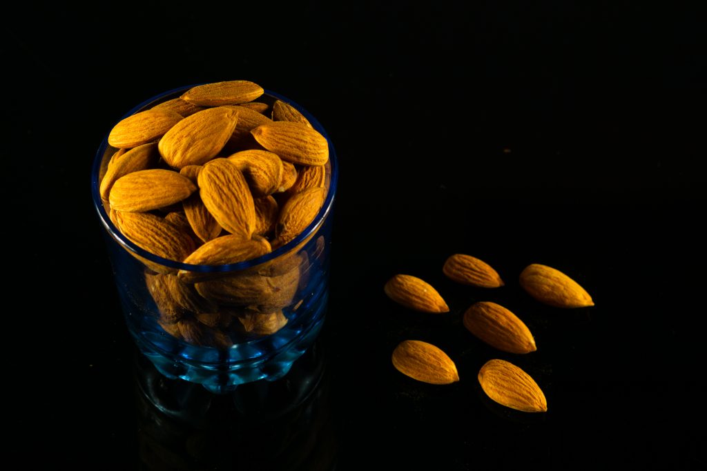 Raw badam stacked in a glass - PixaHive