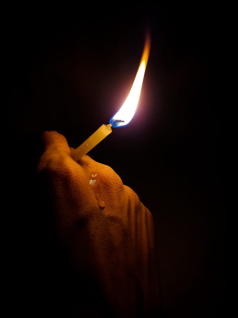 Sad boy with a candle on hand - PixaHive