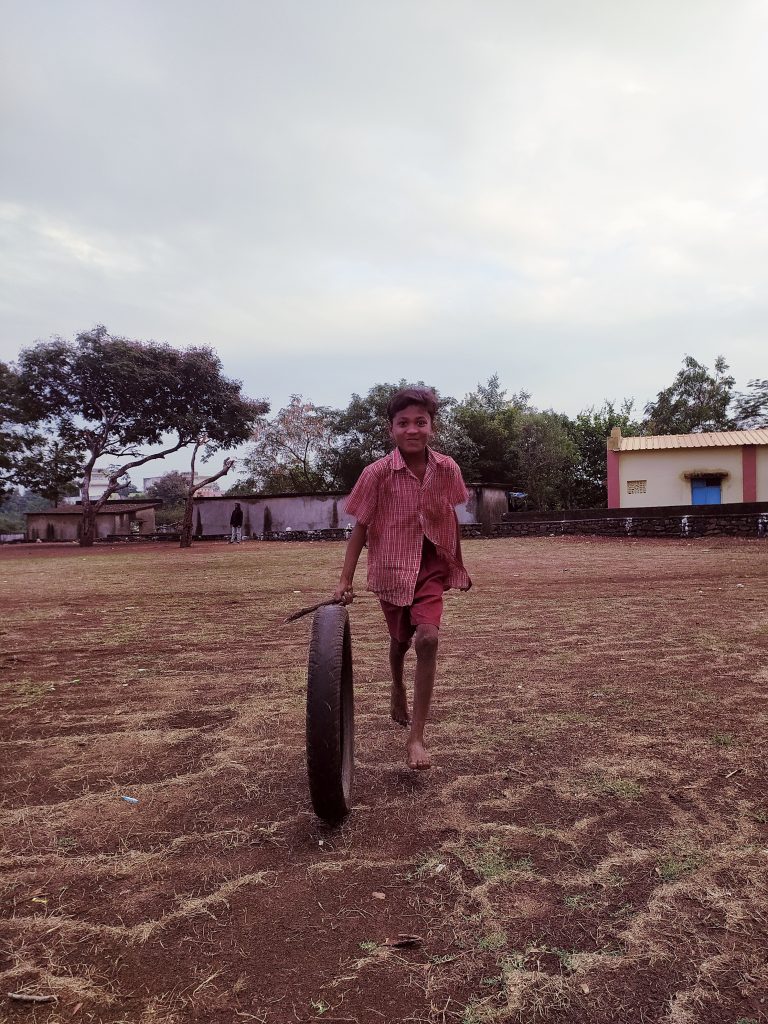 A village child playing with a tire - PixaHive