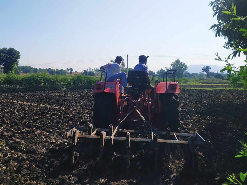 A tractor cultivating a field - PixaHive