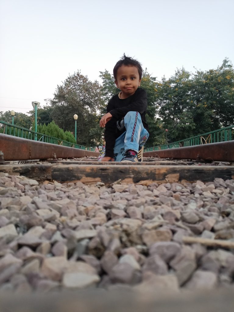 A kid posing on a railway track - PixaHive