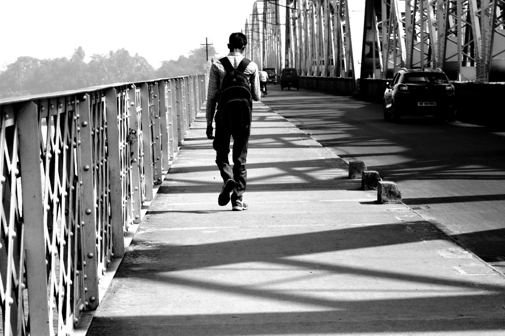 A boy walking on a bridge - PixaHive