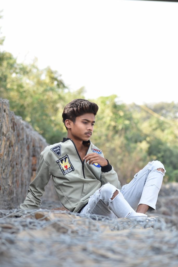 Boy posing while sitting - PixaHive