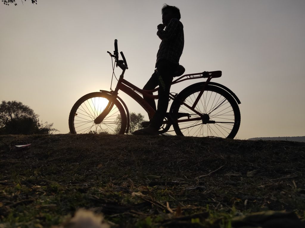 Boy on cycle in sunset - PixaHive