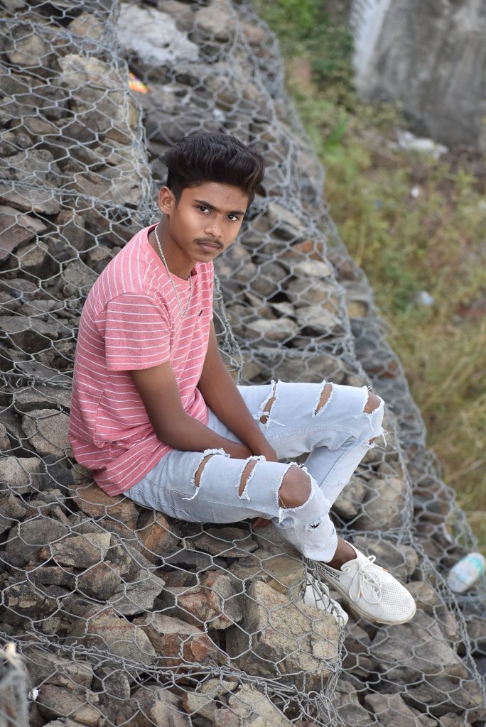 Boy posing while sitting - PixaHive