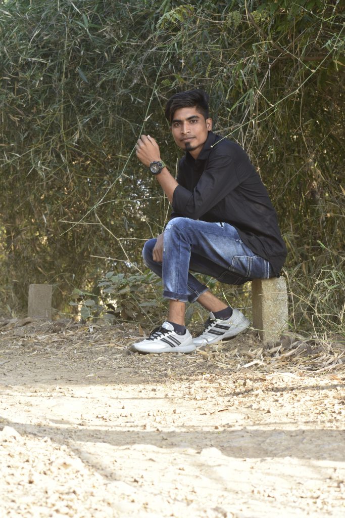 Boy posing while sitting on rock - PixaHive