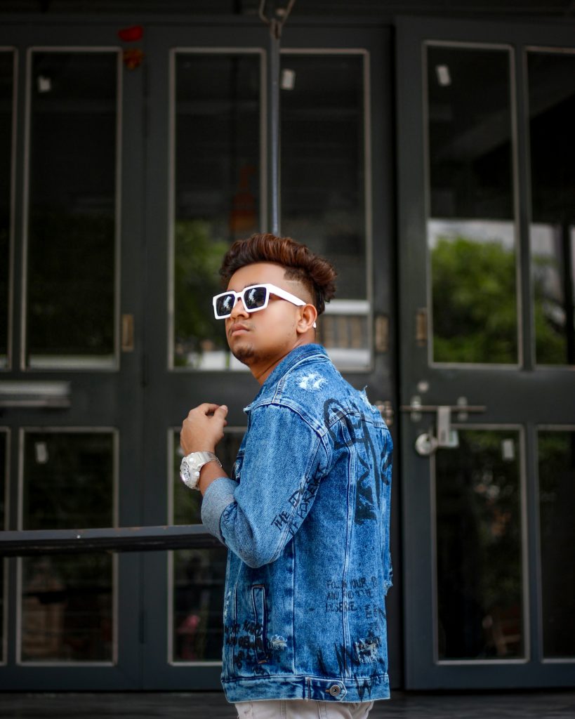 Boy posing in front of door - PixaHive