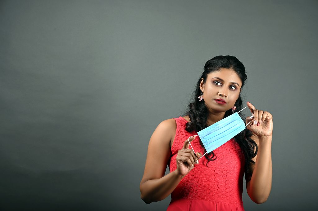 Girl holding facemask in her hand - PixaHive