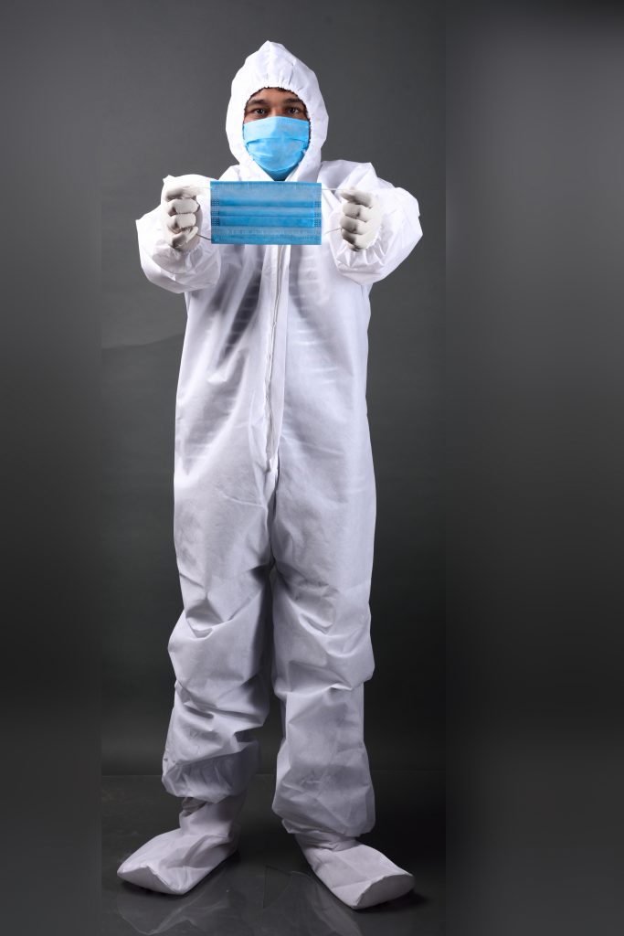 Man in PPE holding mask - PixaHive