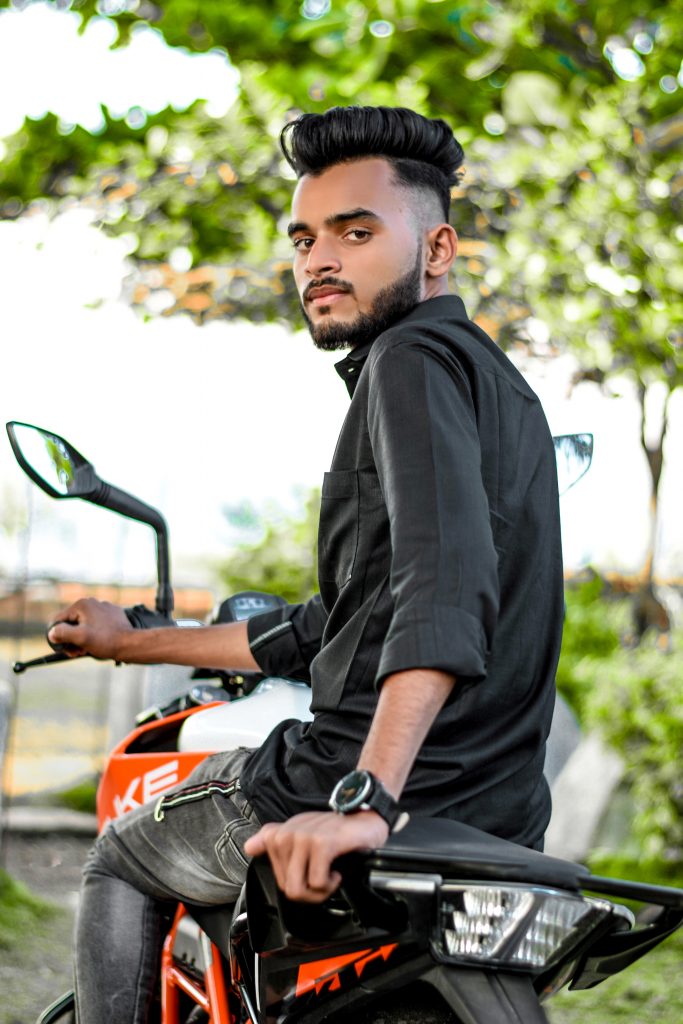 Boy posing on KTM bike in the garden - PixaHive