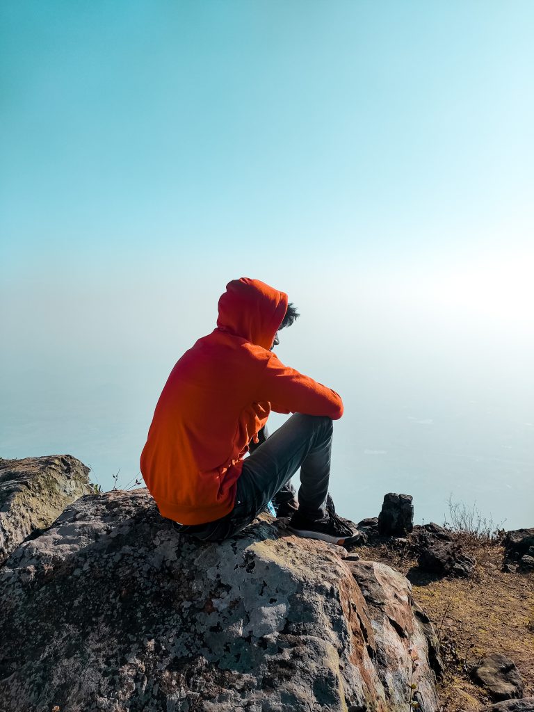 A sad boy on a rock - PixaHive