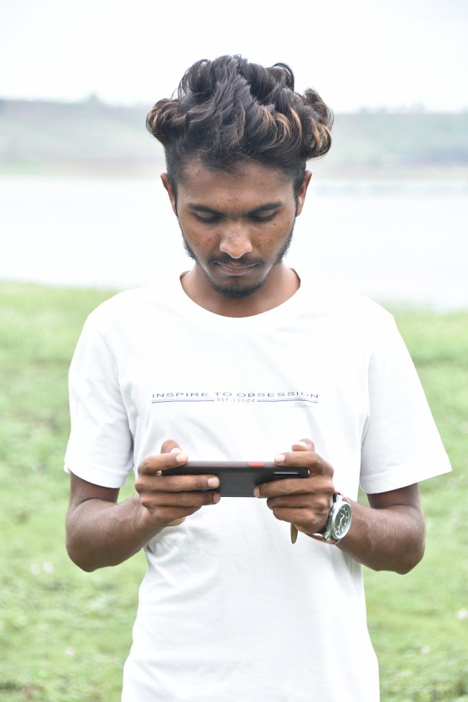 A boy playing mobile game - PixaHive