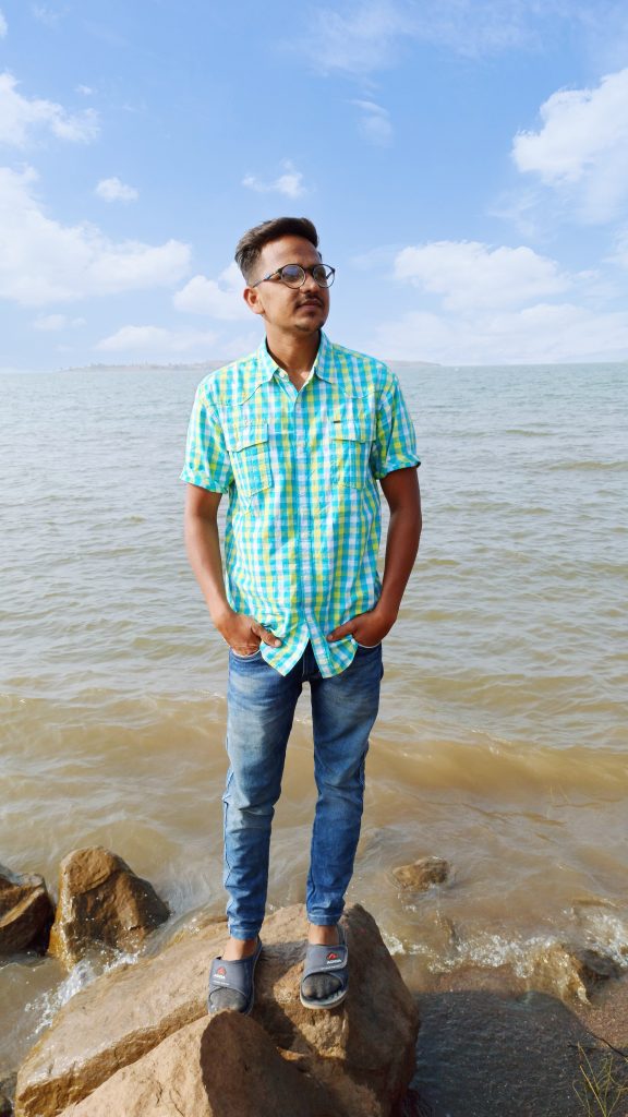 Man standing on the rock near the sea - PixaHive