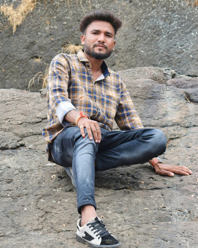Boy posing while sitting on rock - PixaHive