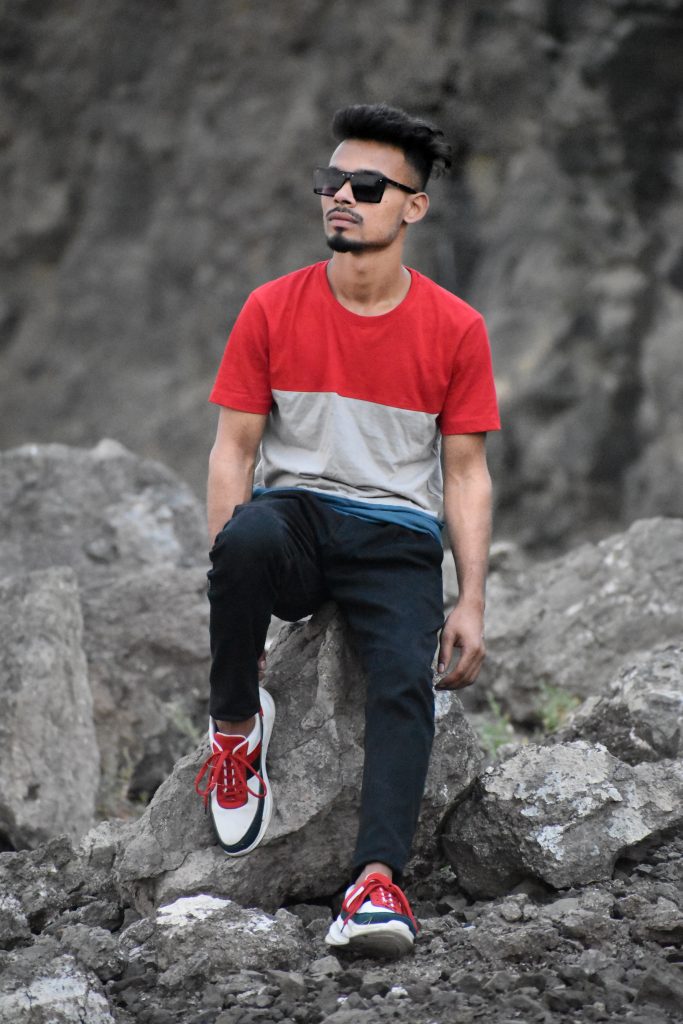 Boy posing while sitting on the rock - PixaHive