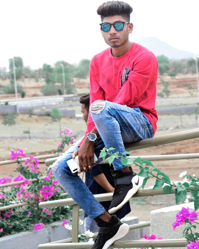 Boy sitting on railing and posing - PixaHive