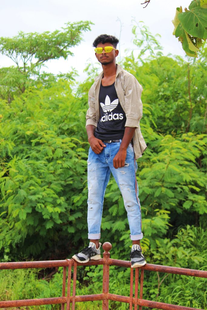 Boy standing on railing and posing - PixaHive