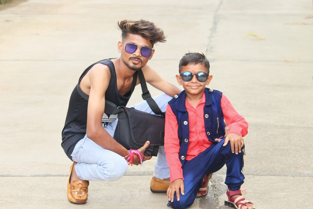 Two boys posing while wearing sunglasses - PixaHive