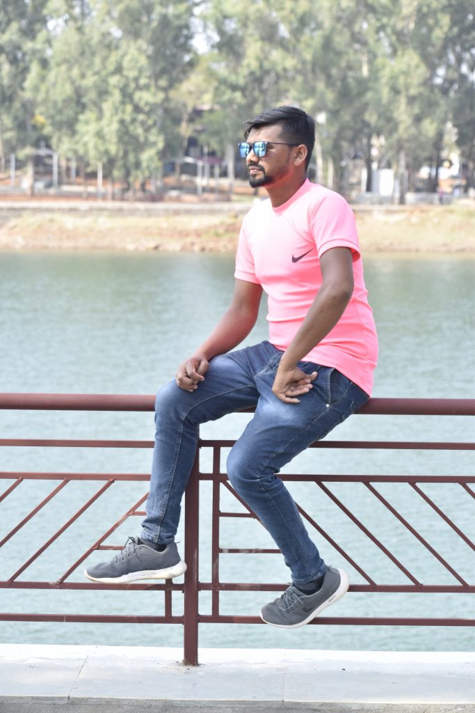 A young boy sitting on railing - PixaHive