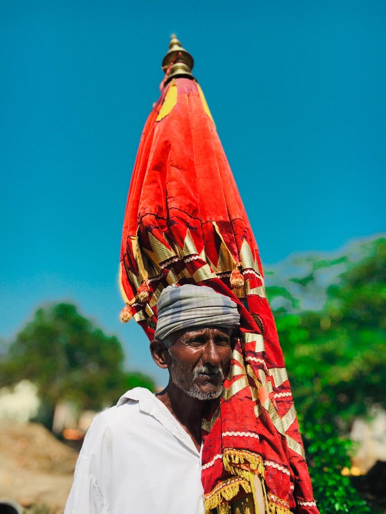 An old man carrying a sacred flag - PixaHive