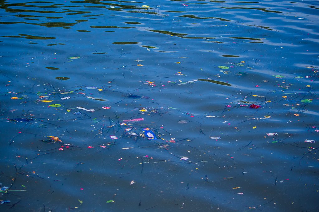 Waste material floating in a river - PixaHive