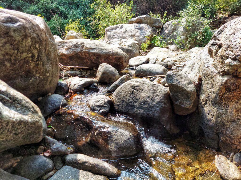 Water flowing through big stones - PixaHive
