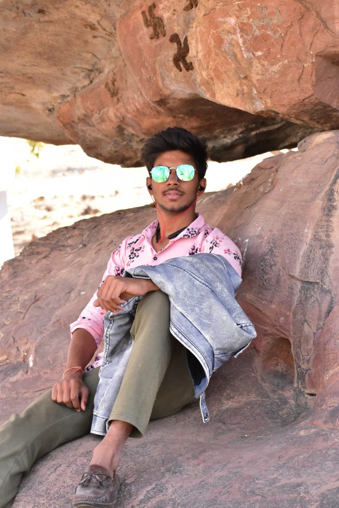 A boy sitting under a rock - PixaHive